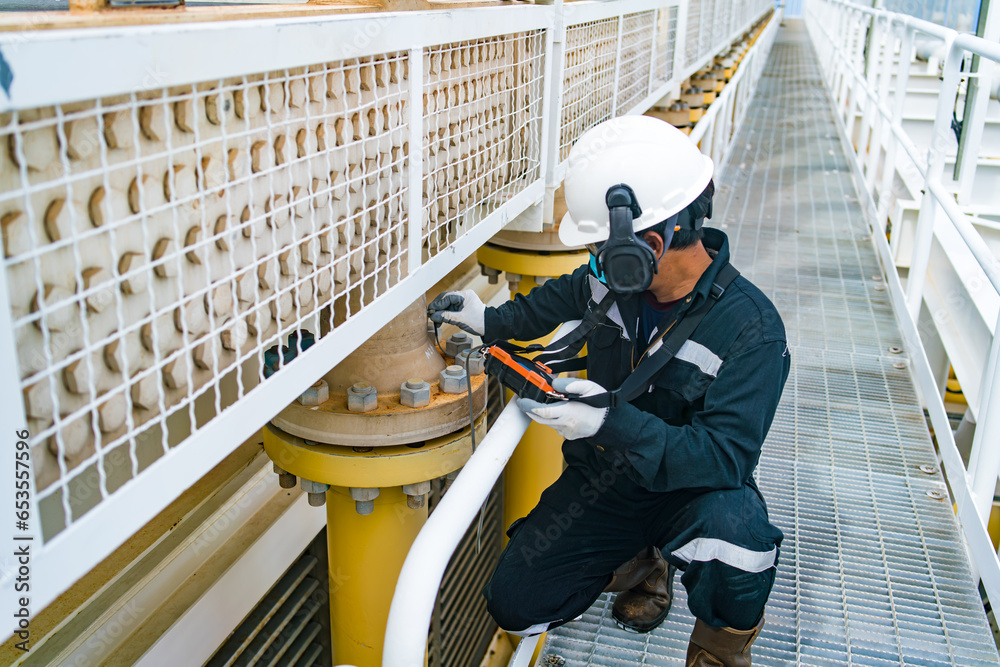 Technicians check the thickness of pipes and heat exchangers using ...