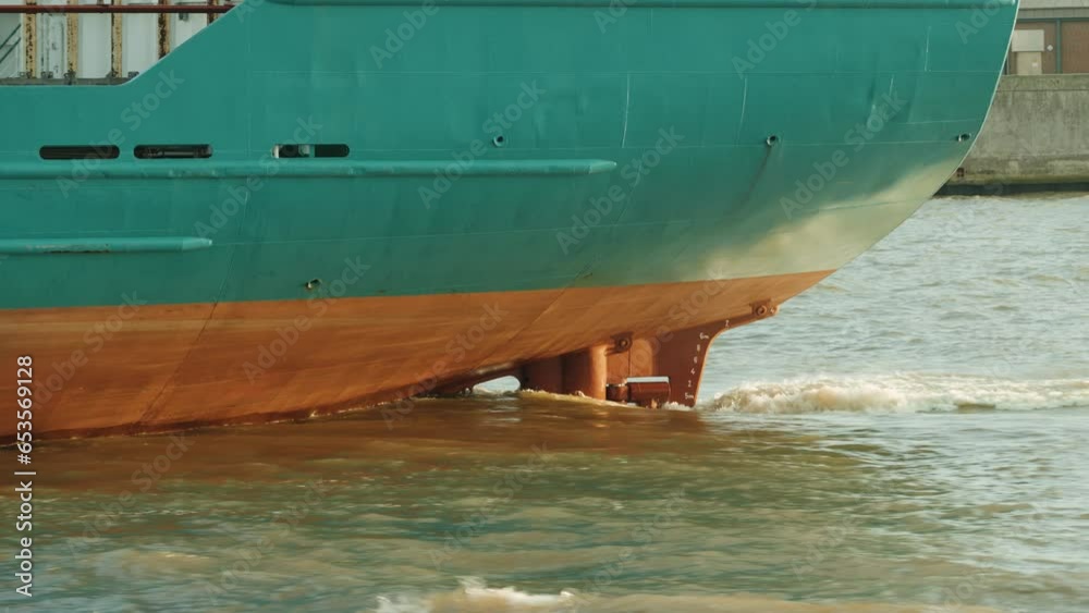 Ship propeller creating prop wash underwater of massive container ship ...