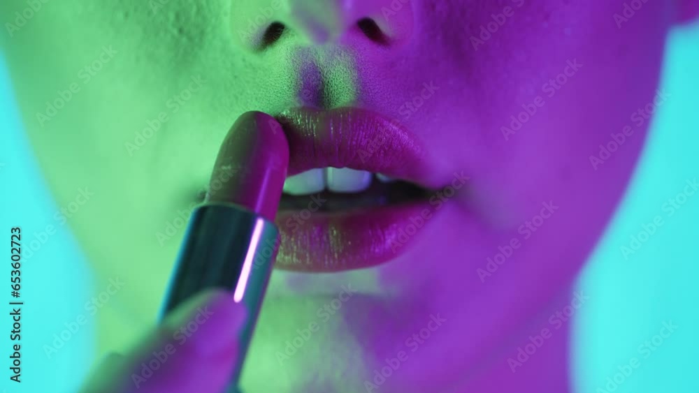 Extreme close up of beautiful full woman lips while she applies red ...