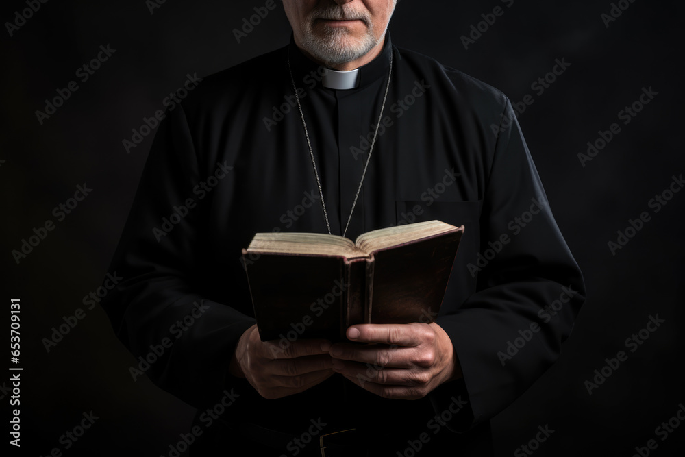 Catholic Christian Church Priest, Attired In Black Cassock Robe, Holds ...