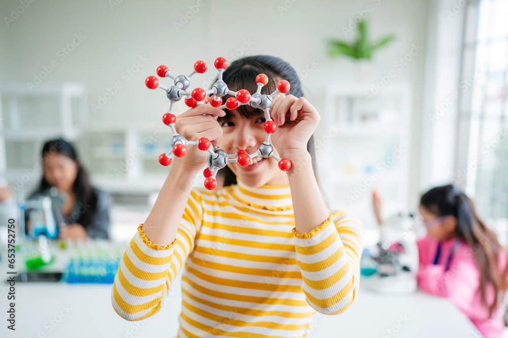 Girl having fun time with holding molecular model learning chemistry ...