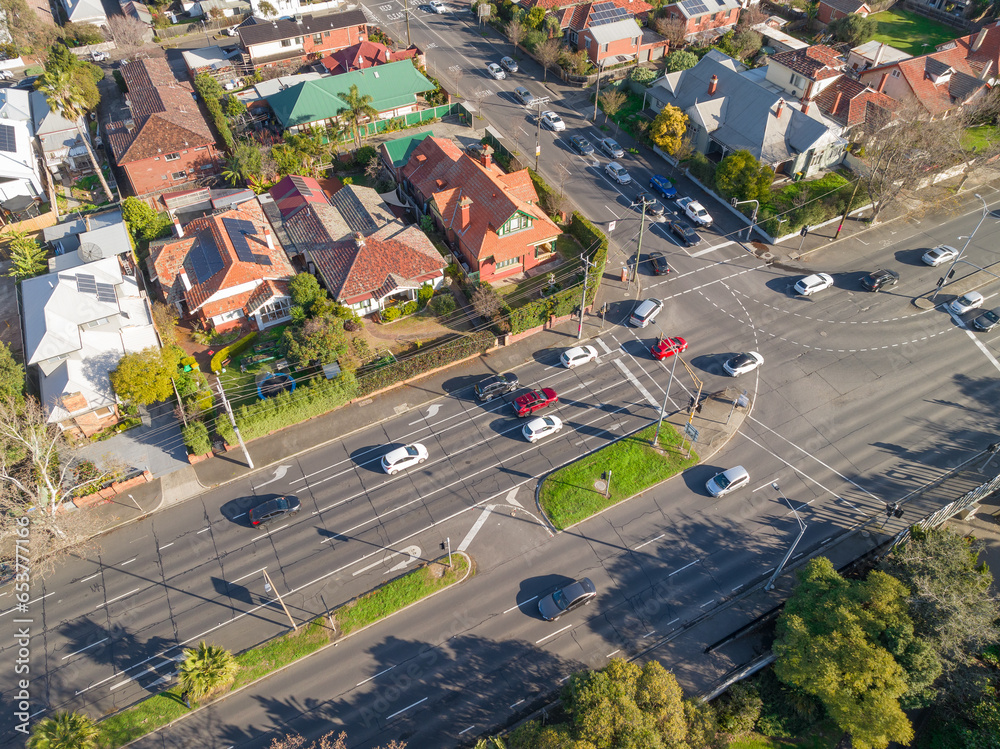 Aerial view of traffic at a busy intersection around inner city housing ...