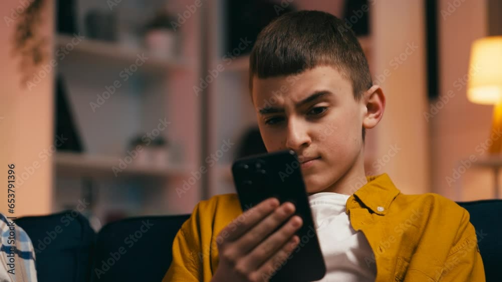 Teen boy scrolling social networks on smartphone, virtual life, digital age Stock 비디오 | Adobe Stock