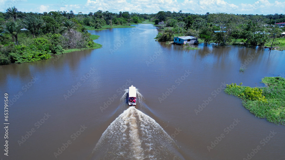 Boat sailing at Amazon river at Amazon forest at Amazonas state Brazil ...