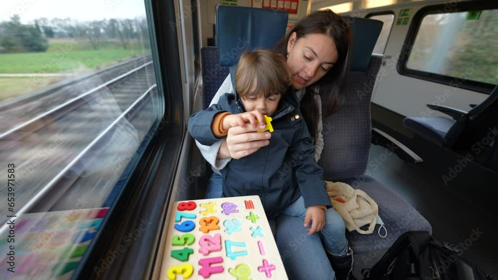 Proactive mom facilitating an educational activity for her son during a ...