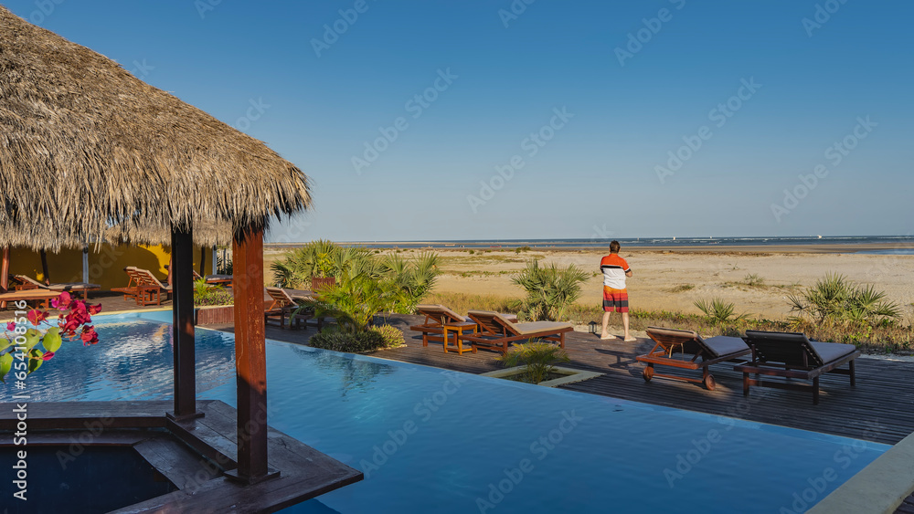 Recreation area on the ocean. Sun loungers and a canopy with a thatched ...