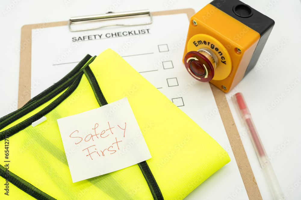 Safety First message on paper. Reflective vest, safety hat or helmet ...