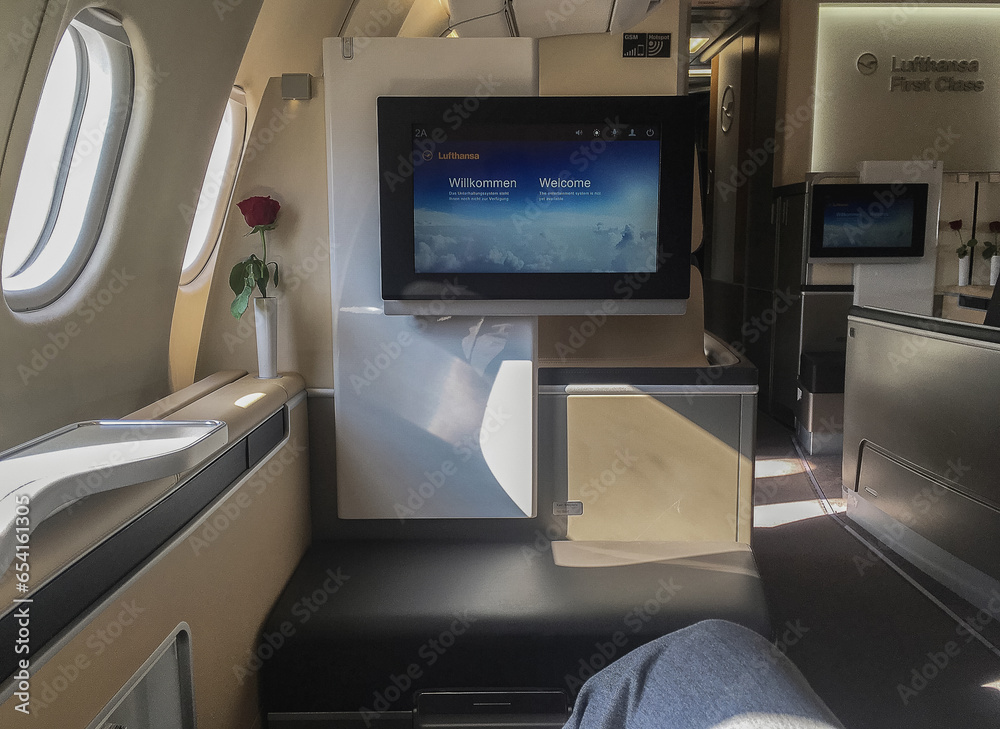 View into First Class cabin with single and double lie flat suite seat ...