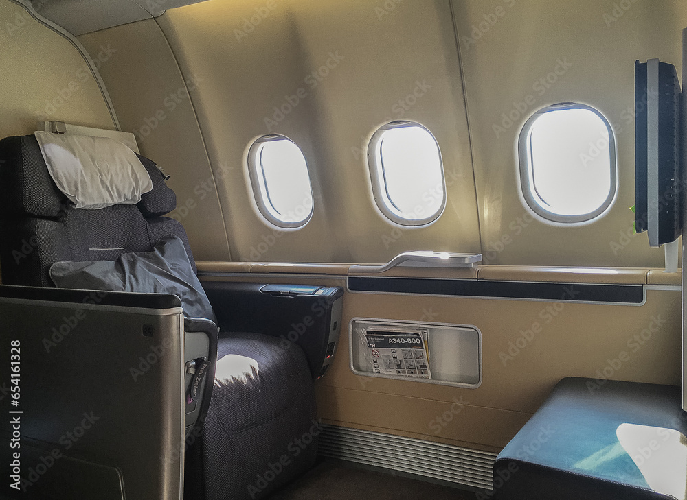 View into First Class cabin with single and double lie flat suite seat ...