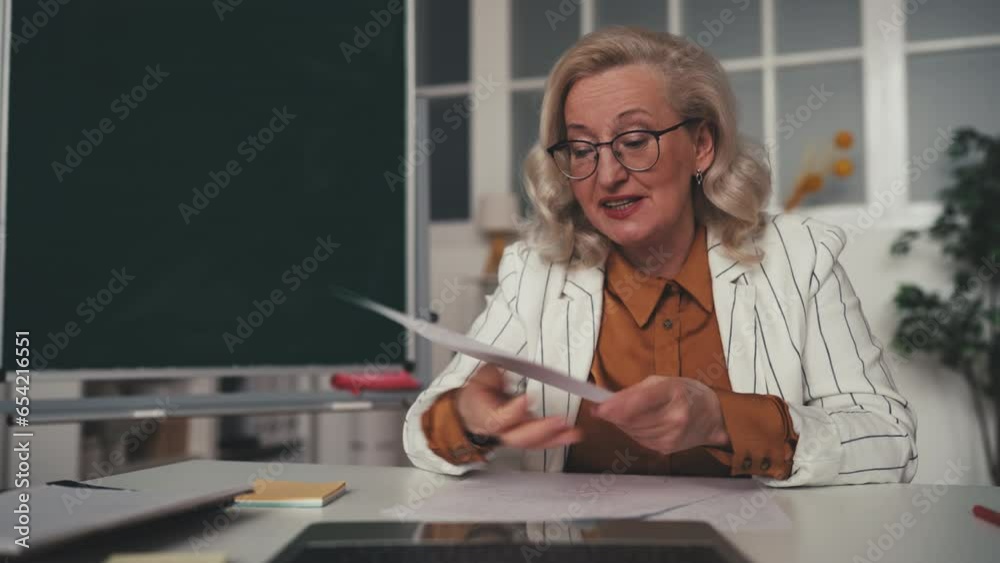 Strict teacher in her 50s scolding students for lazy work via laptop ...