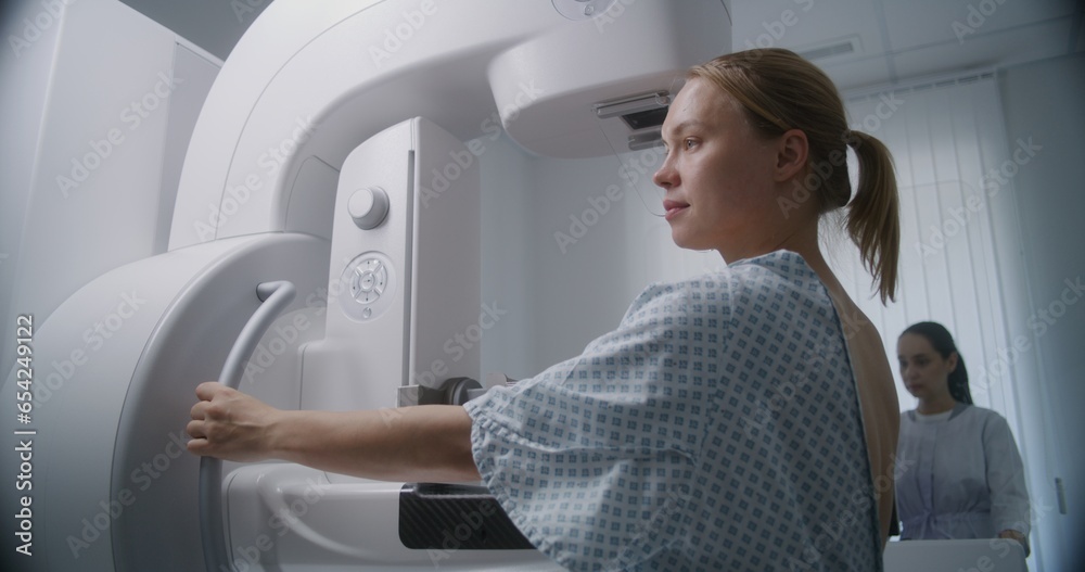 Caucasian adult woman stands in hospital radiology room. Female patient ...