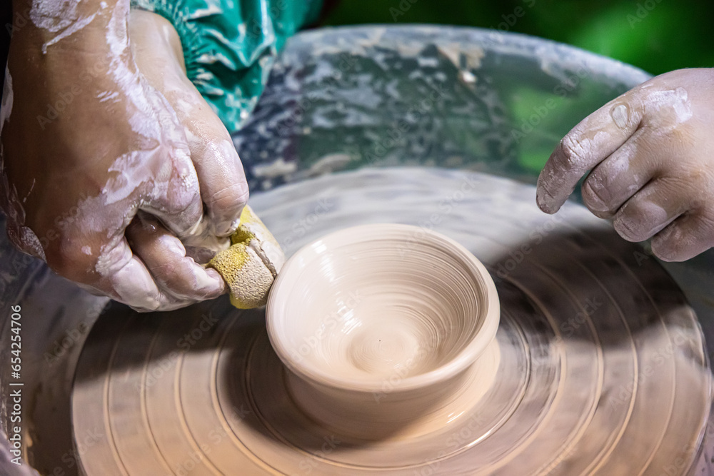 budding potter embraces the challenges of shaping clay into a plate ...