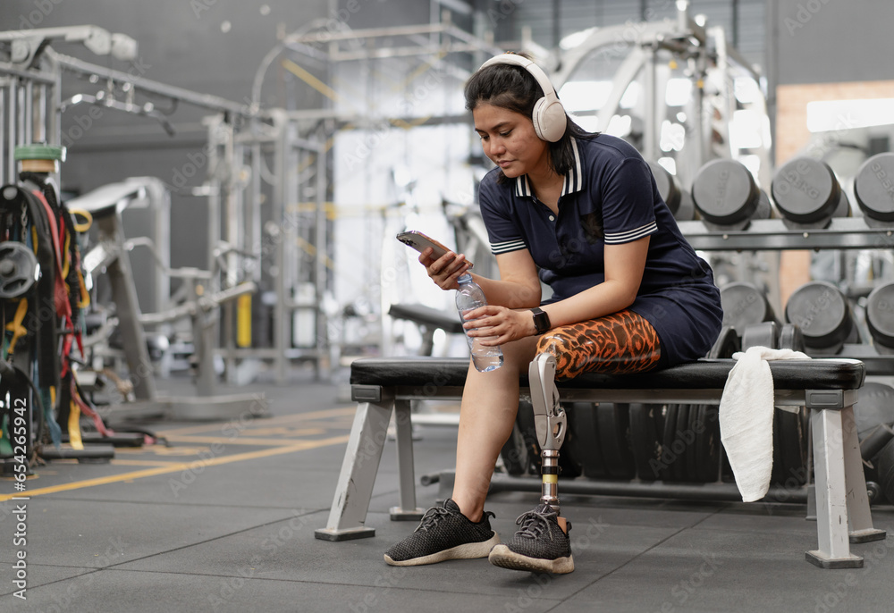 Confident woman with artificial leg sits relax after exercising in ...