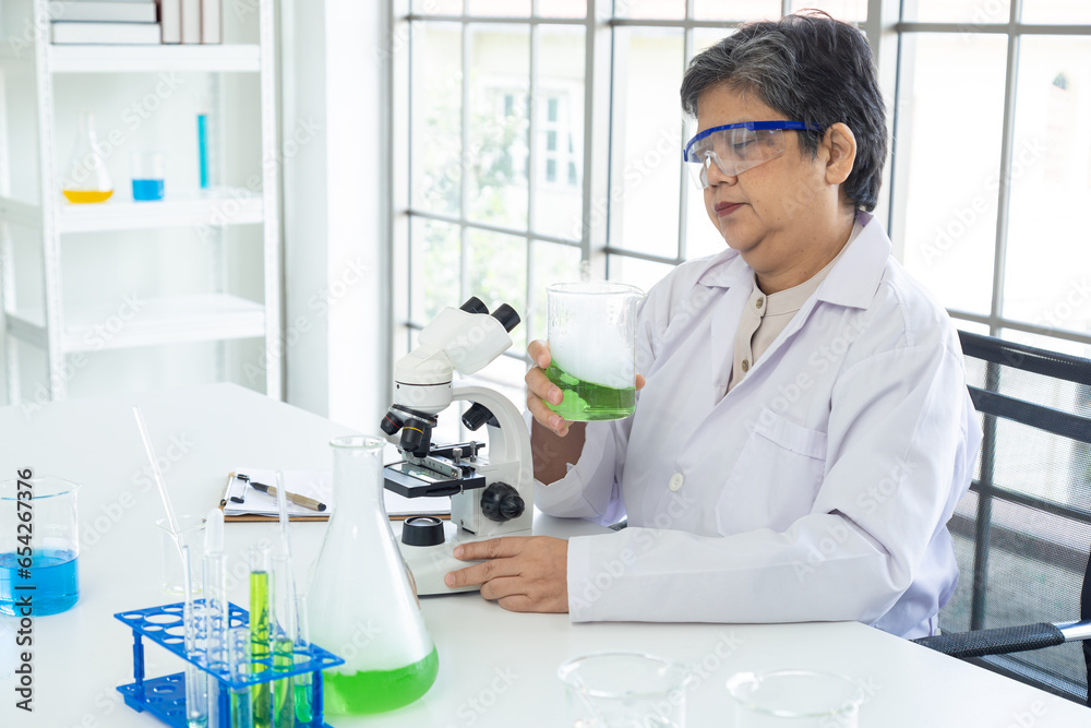 Ability of elderly employee working in science laboratory, senior woman ...