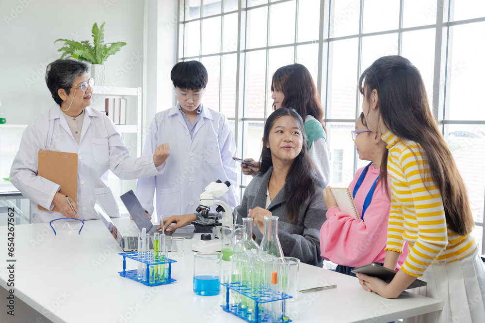 Group of Asian secondary students have fun in science laboratory class ...