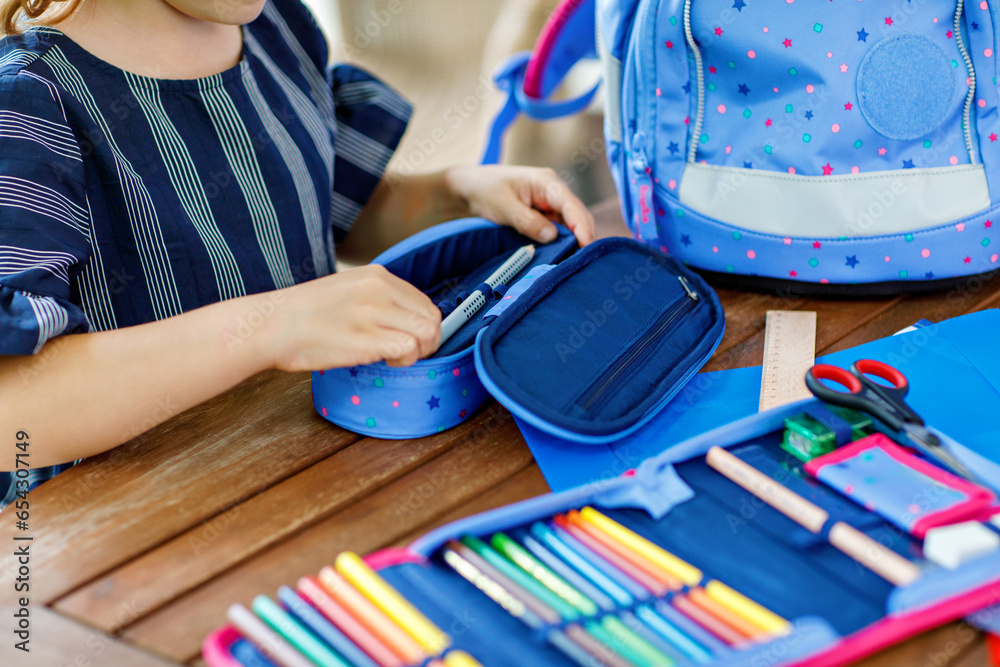 Happy smiling girl preparing for school her backpack. First day of ...