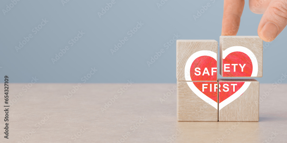Safety first, heart shaped icon on wooden cubes in human hand. work ...