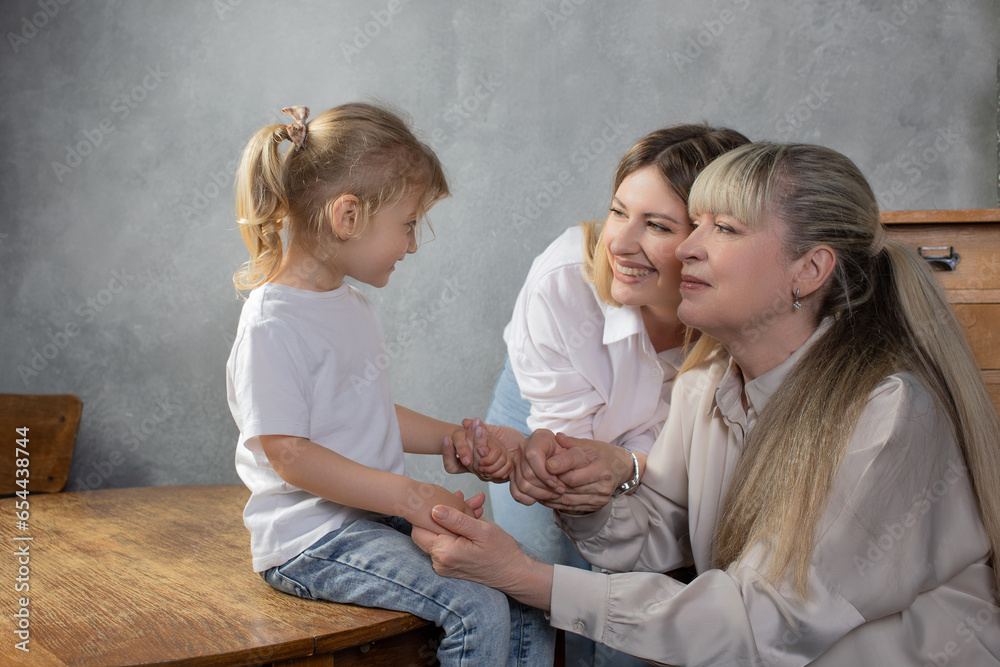 happy family communicates, three generations of women together. Mom ...