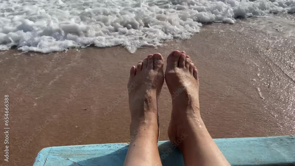 woman legs on sand beach with waving sea, female legs with problem with ...