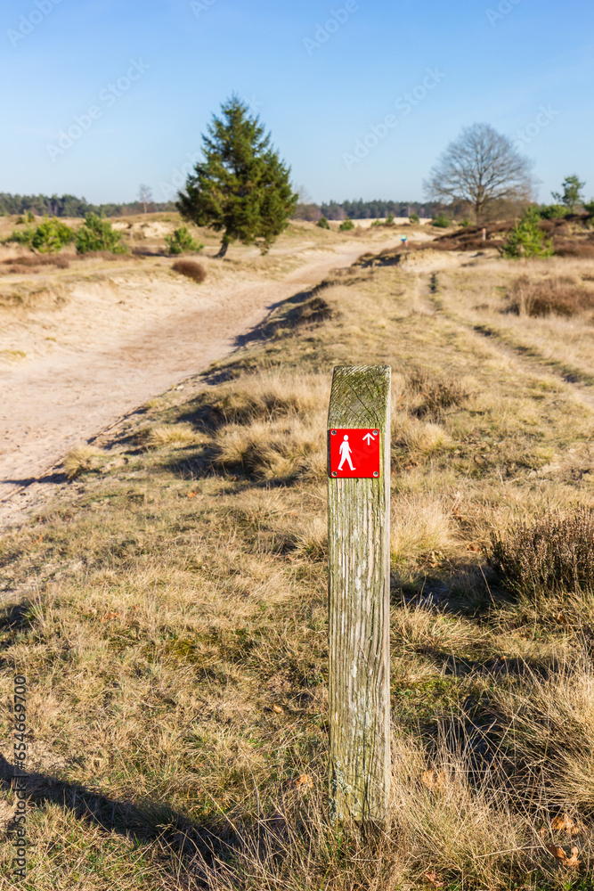 Red sign pointing to the walking direction in Drents Friese Wold ...