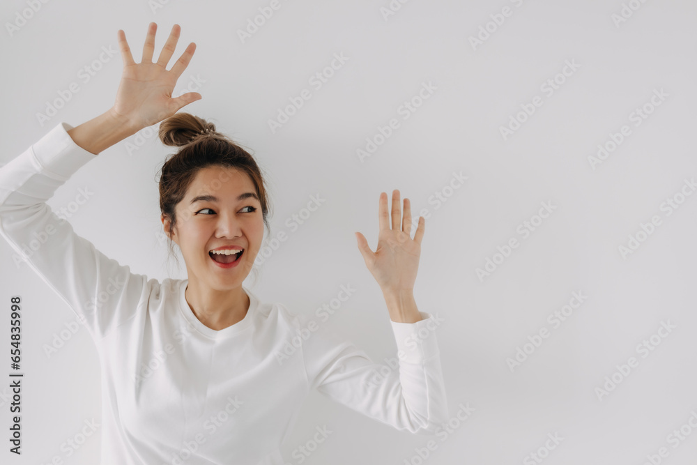 Happy Thai Asian woman bun hair, waving both hands gesture to say hello ...