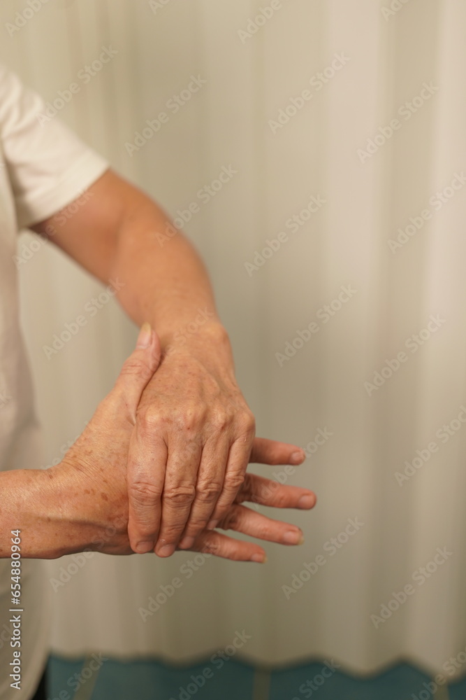 A woman uses her other hand to feel pain and tingling. along with ...