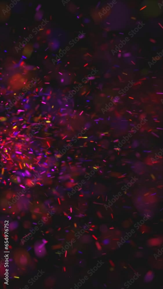 Vertical video - burning multicolored hot sparks and embers fire ...