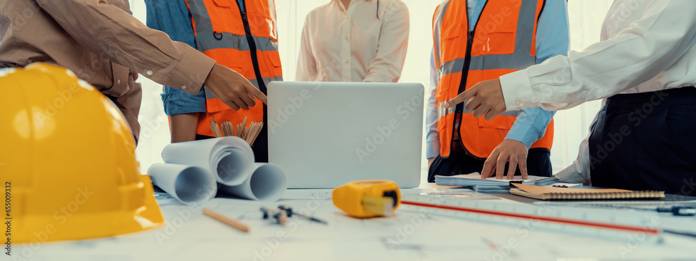 Engineer partner drawing and working on blueprint design together on ...