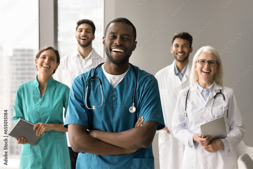 Happy African American surgeon man with folded arms standing in front ...