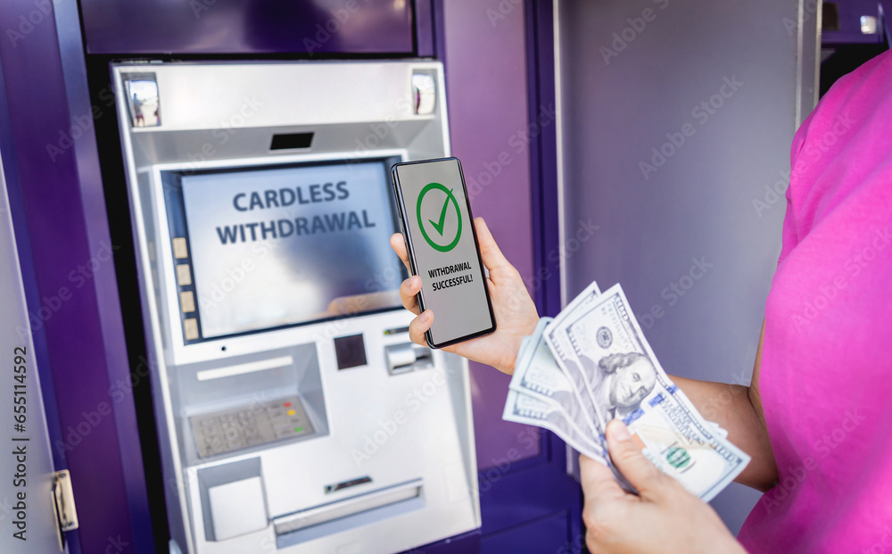 Young woman using the smart phone for cardless withdrawing the cash ...