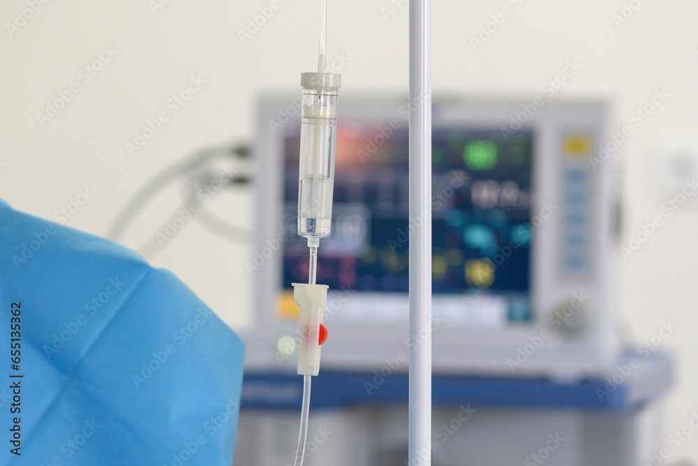 A drip with saline solution in the operating room close-up. Syringe ...