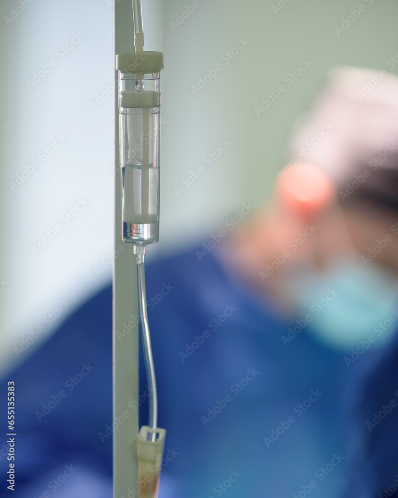 A drip with saline solution in the operating room close-up. Syringe ...