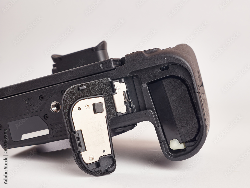 The digital mirrorless camera is shown below with the battery ...