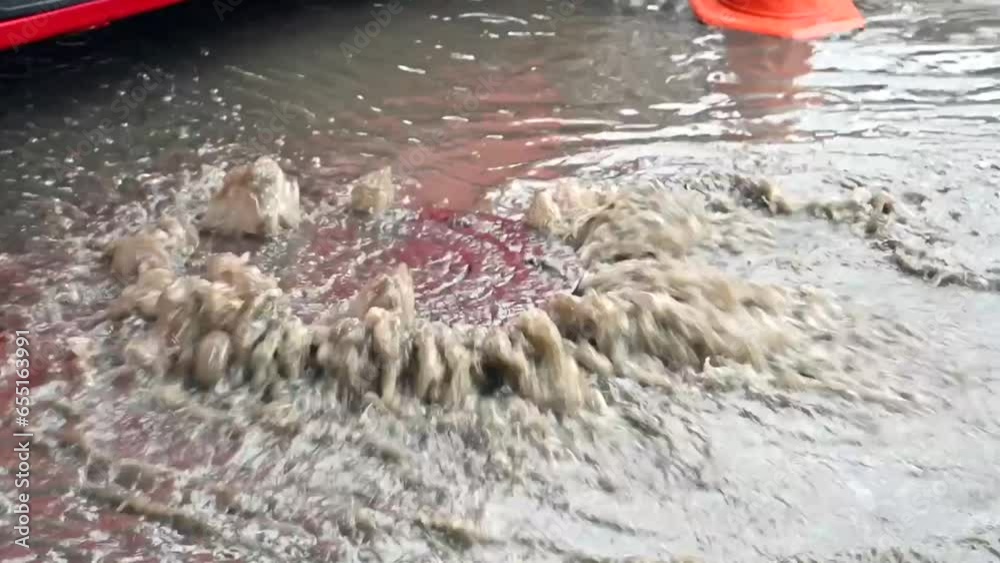 Drain after severe spring storm on flooded street. Sewage overflow on ...