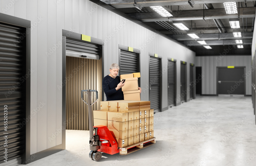 Man with boxes in warehouse building. Male rents storage unit. Guy near ...