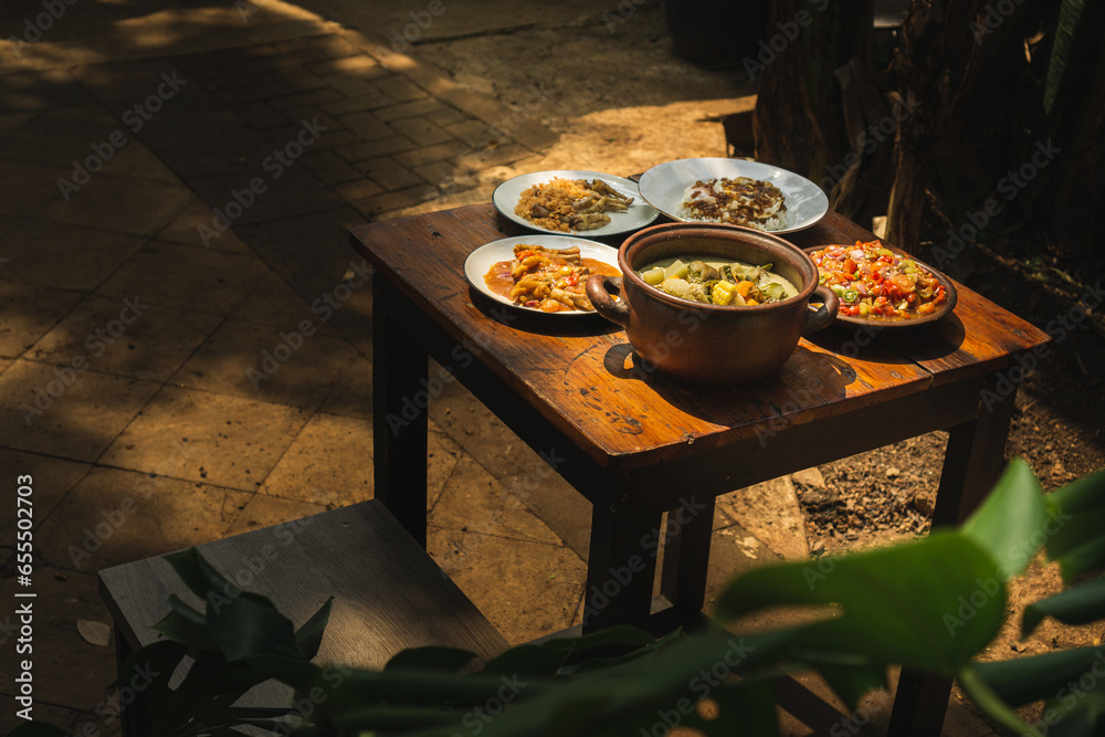 wooden table with indonesian cuisine, nasi telor, sambal matah, sayur ... wooden table with indonesian cuisine, nasi telor, sambal matah, sayur ...