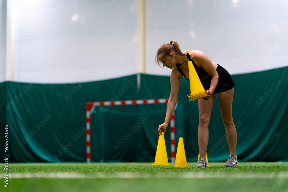 young girl soccer player displays sports equipment chips on a closed ...