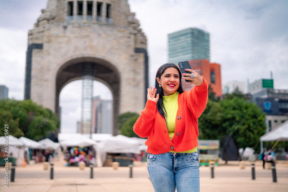 Smiling young Hispanic ethnic woman tourist taking selfie with ...