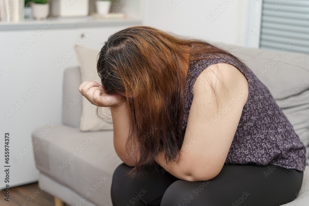 Sad Overweight plus size woman thinking about problems on sofa upset ...