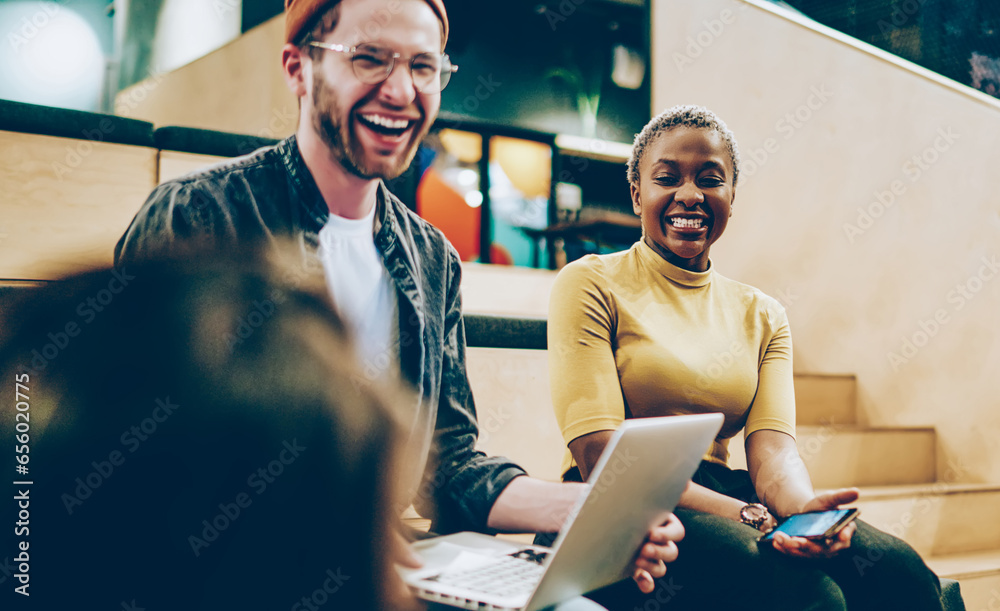 overjoyed crew of diversity hipster colleagues laughing at jokes while ...