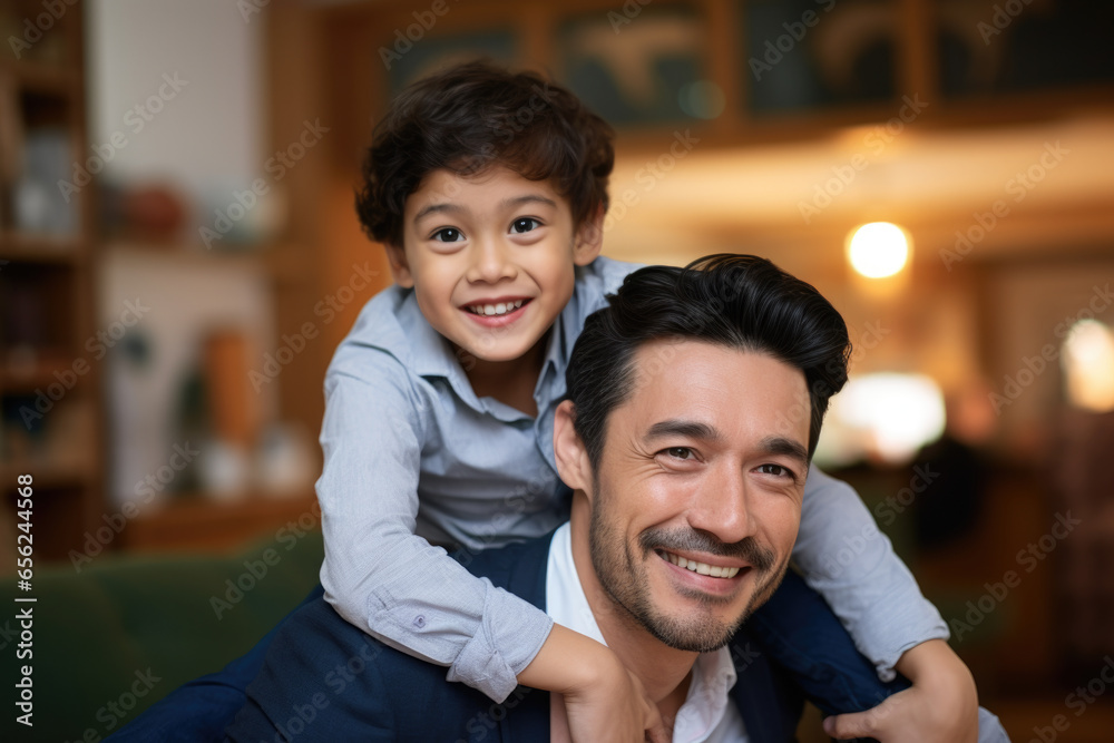 Man is seen holding little boy on his shoulders. This heartwarming ...