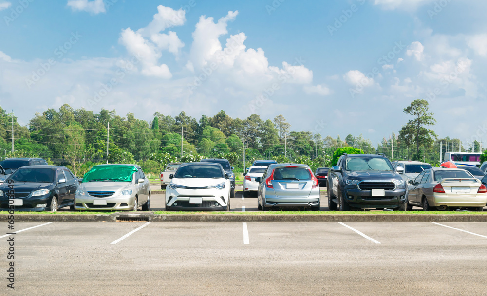 Cars parking in asphalt parking lot in a row with blue sky background ...