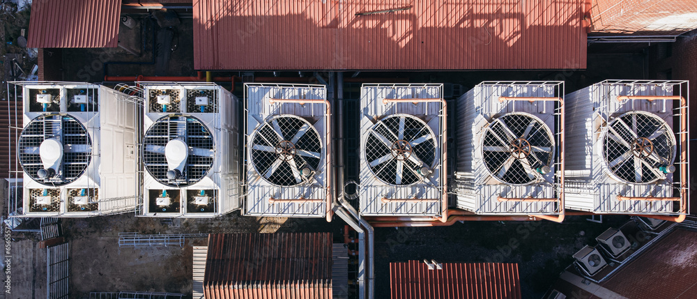 Air conditioner compressor installed on the roof of a building, along ...