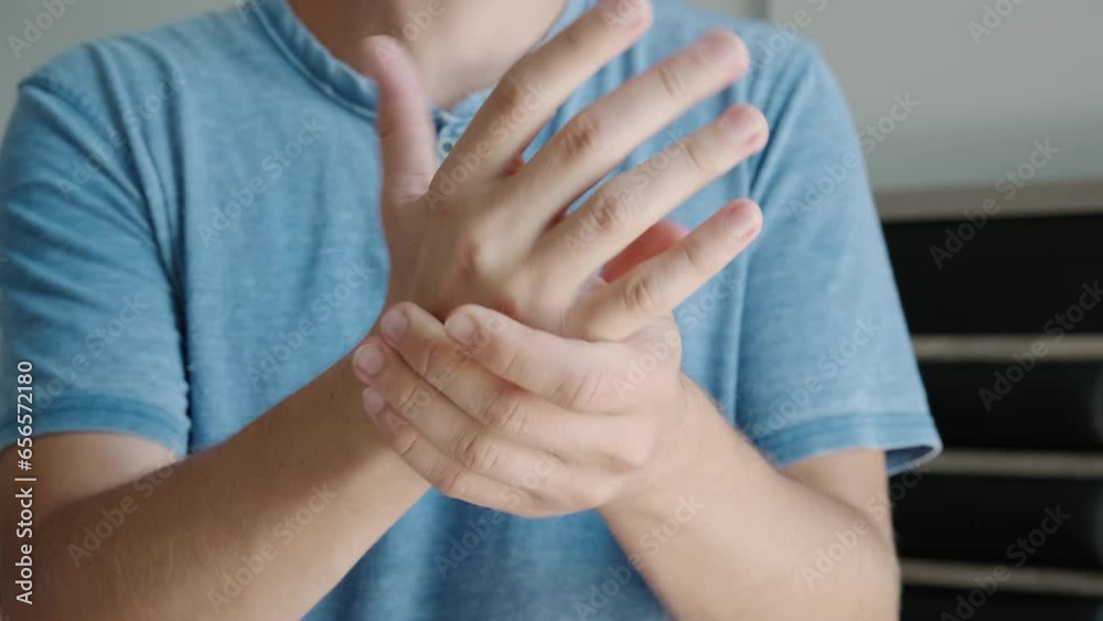 Man suffering from hand and wirst pain. Male massaging painful hand ...