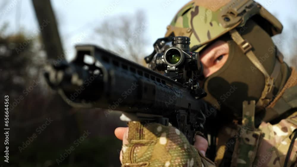 Muzzle of a machine gun close-up, blurred background of a man. A ...