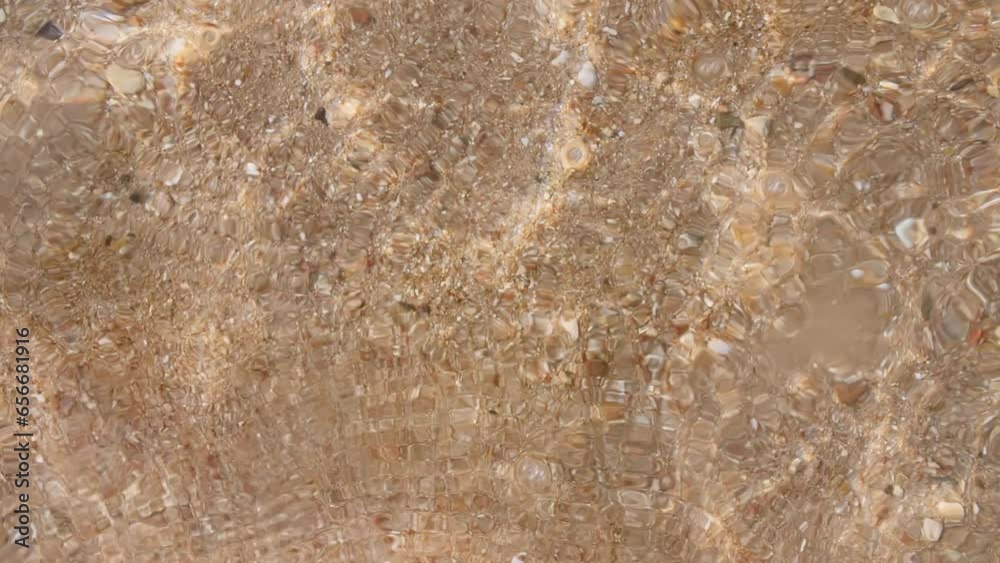 Water splash. Sand, corals. Pure water with reflections sunlight and ...