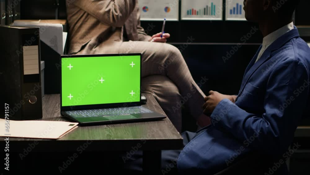 Modern laptop with blank green screen positioned on desk in police ...