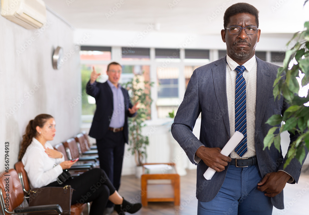 Angry boss shouts yells at hired employee African American man in ...