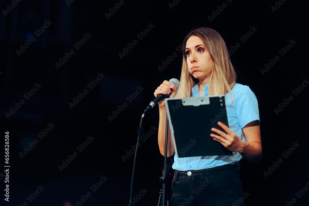 Stressed Speaker Holding a Clipboard Taking on a Microphone ion a Stage ...