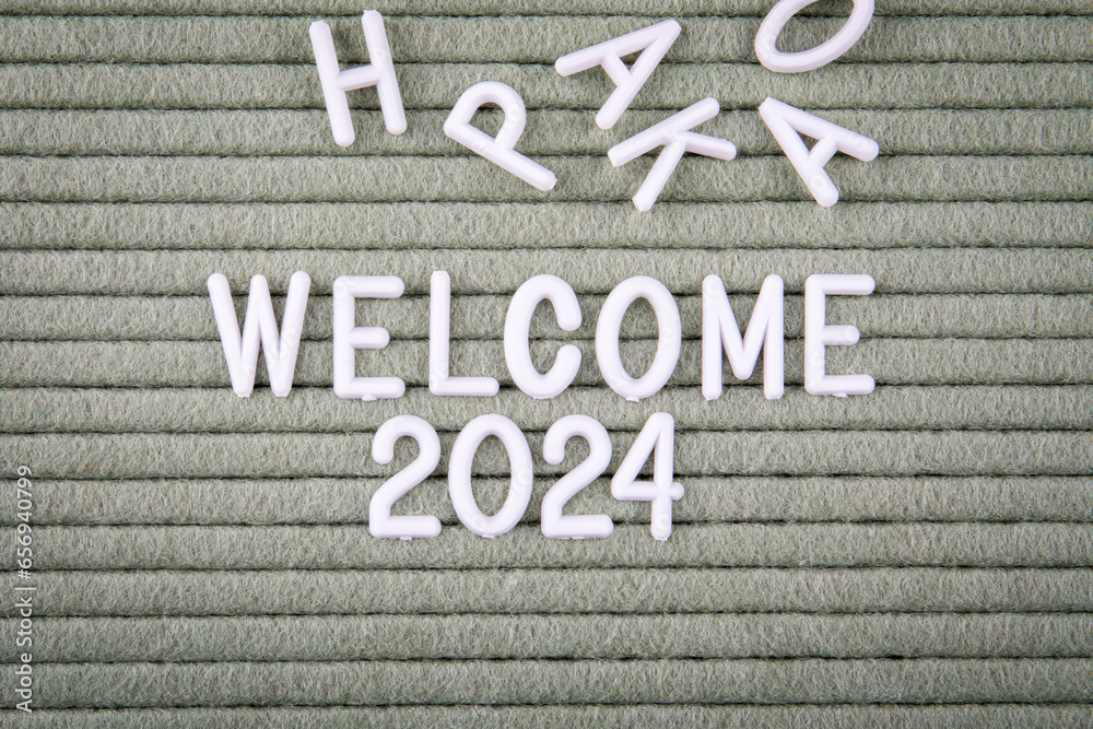 WELCOME 2024 Concept. White letters of the alphabet on a green ...